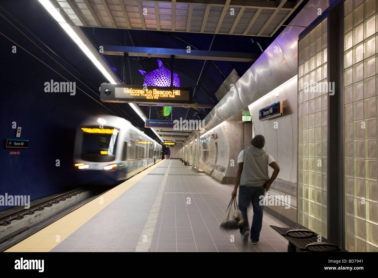 Young African American Man Boarding a Train at the Beacon Hill Station Sound Transit Link Light ...
