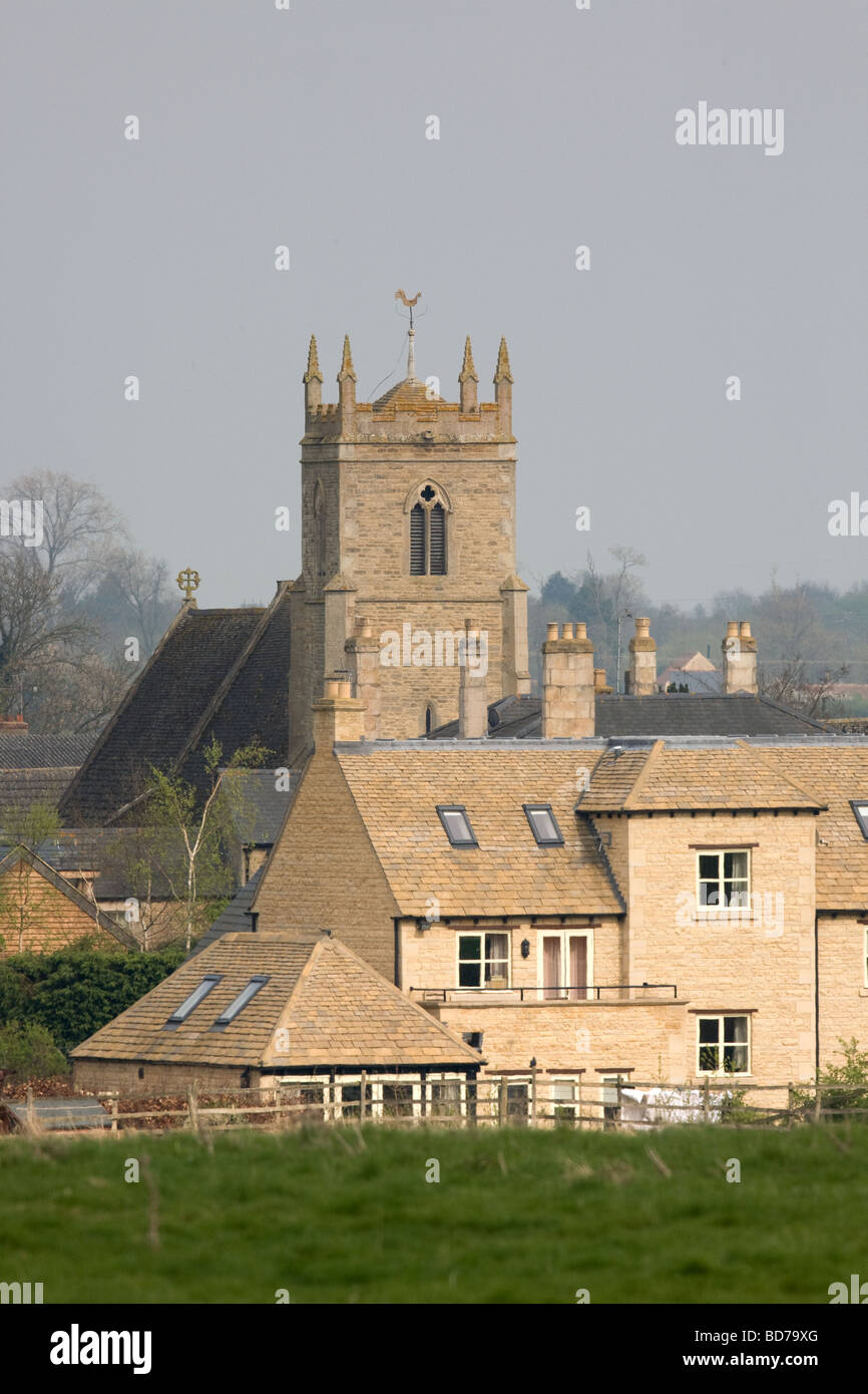Large New House Built In A Front Of A Church Stock Photo - Alamy