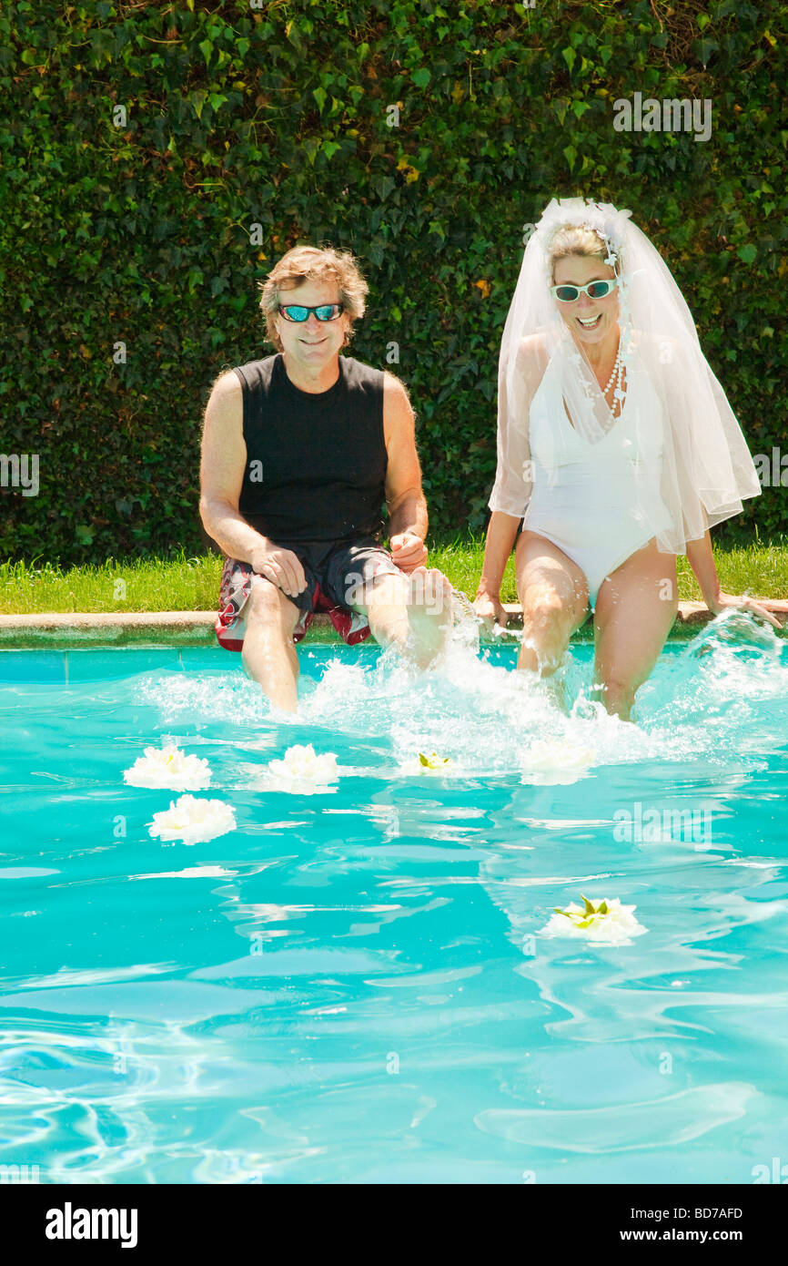 Bride and groom in swimming pool Stock Photo - Alamy