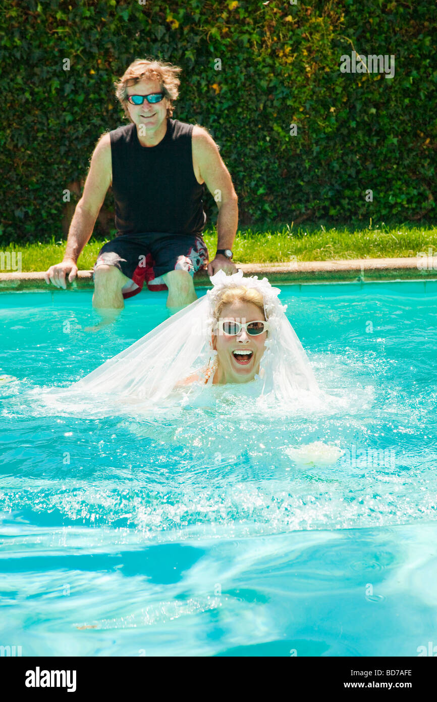 Bride and groom in swimming pool Stock Photo - Alamy