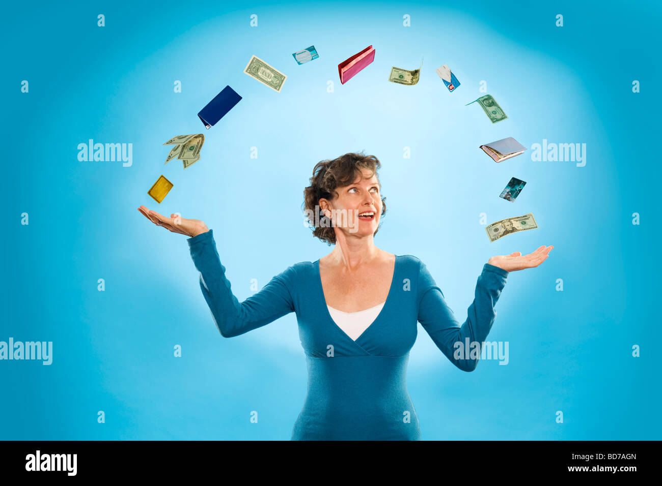 Woman juggling financial items Stock Photo - Alamy
