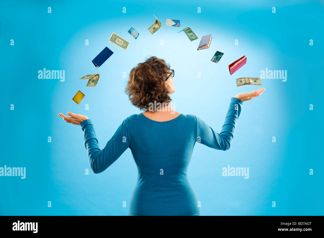 Woman juggling financial items Stock Photo - Alamy