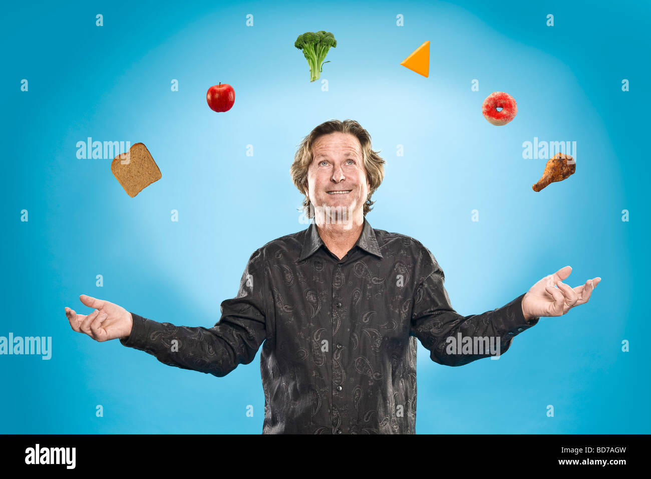 Man juggling different foods Stock Photo - Alamy