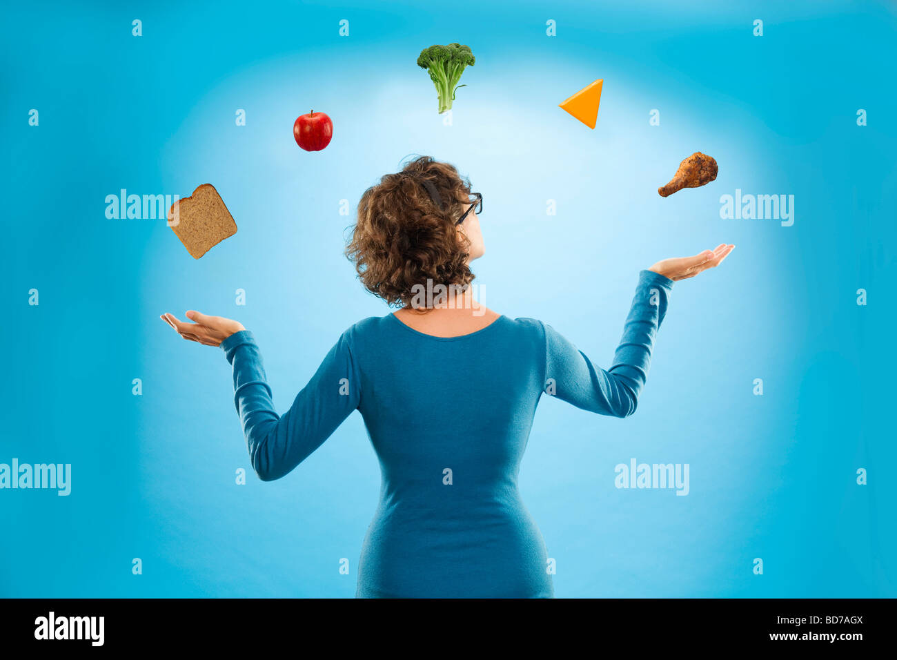 Woman juggling different foods Stock Photo - Alamy