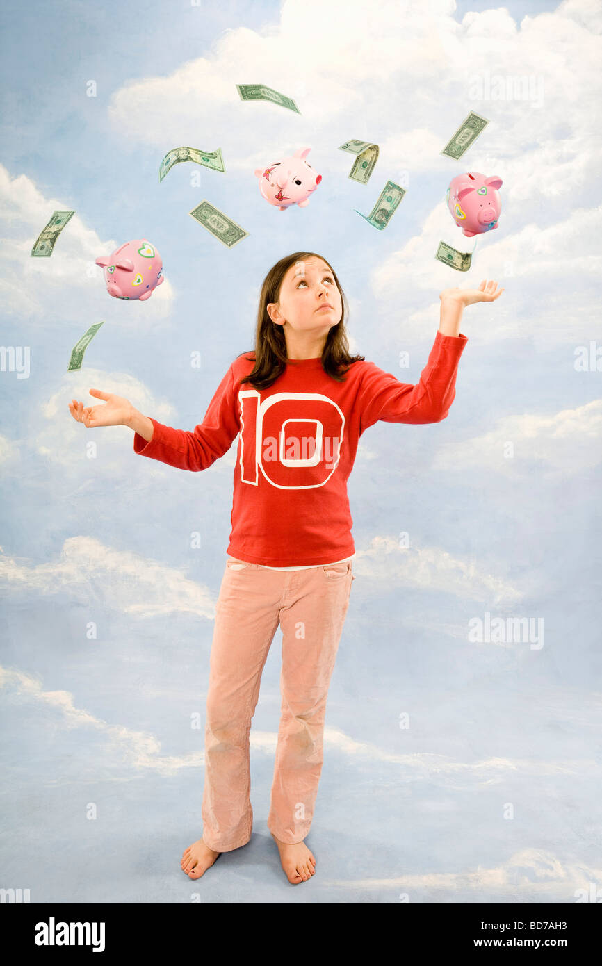 Girl juggling money Stock Photo - Alamy