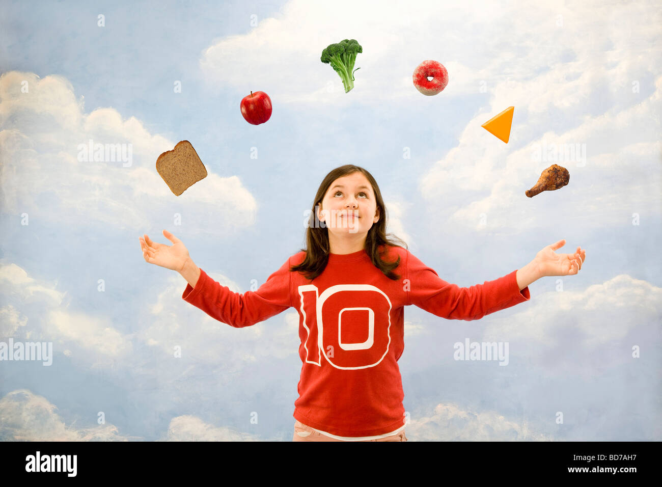 Girl juggling different foods Stock Photo - Alamy