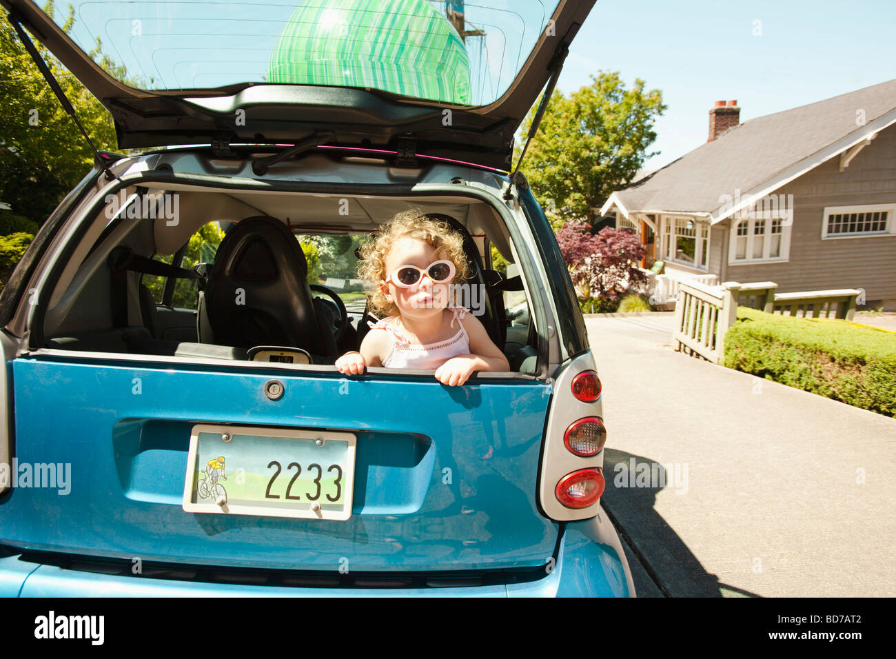 Young girl in back of smart car Stock Photo - Alamy