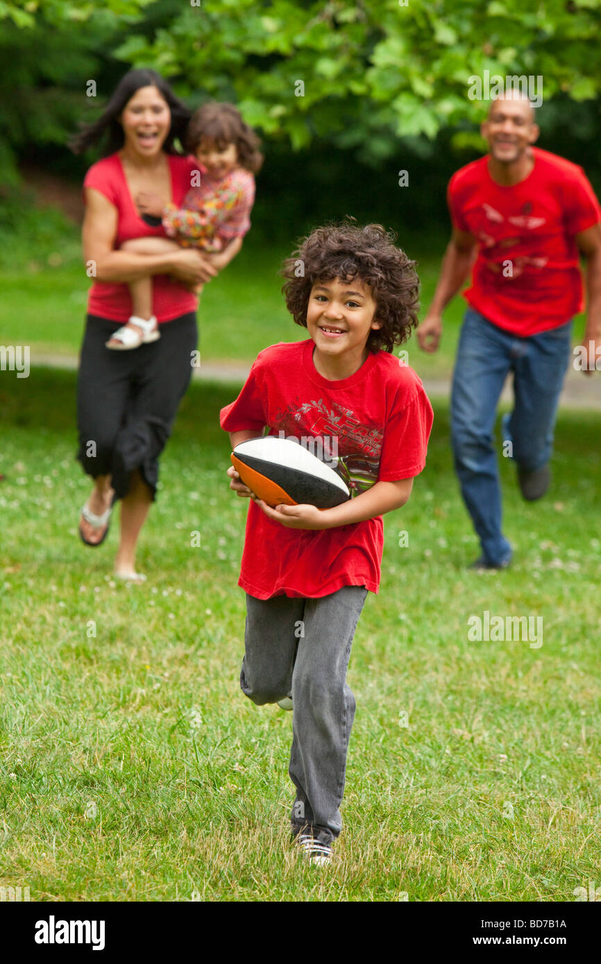 Family running in park Stock Photo - Alamy