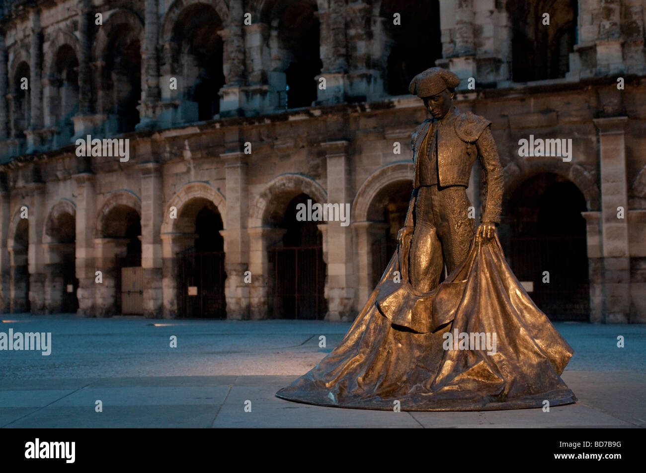 Roman arena at night with the Toreador Les Arenes Amphitheatre in Nimes ...