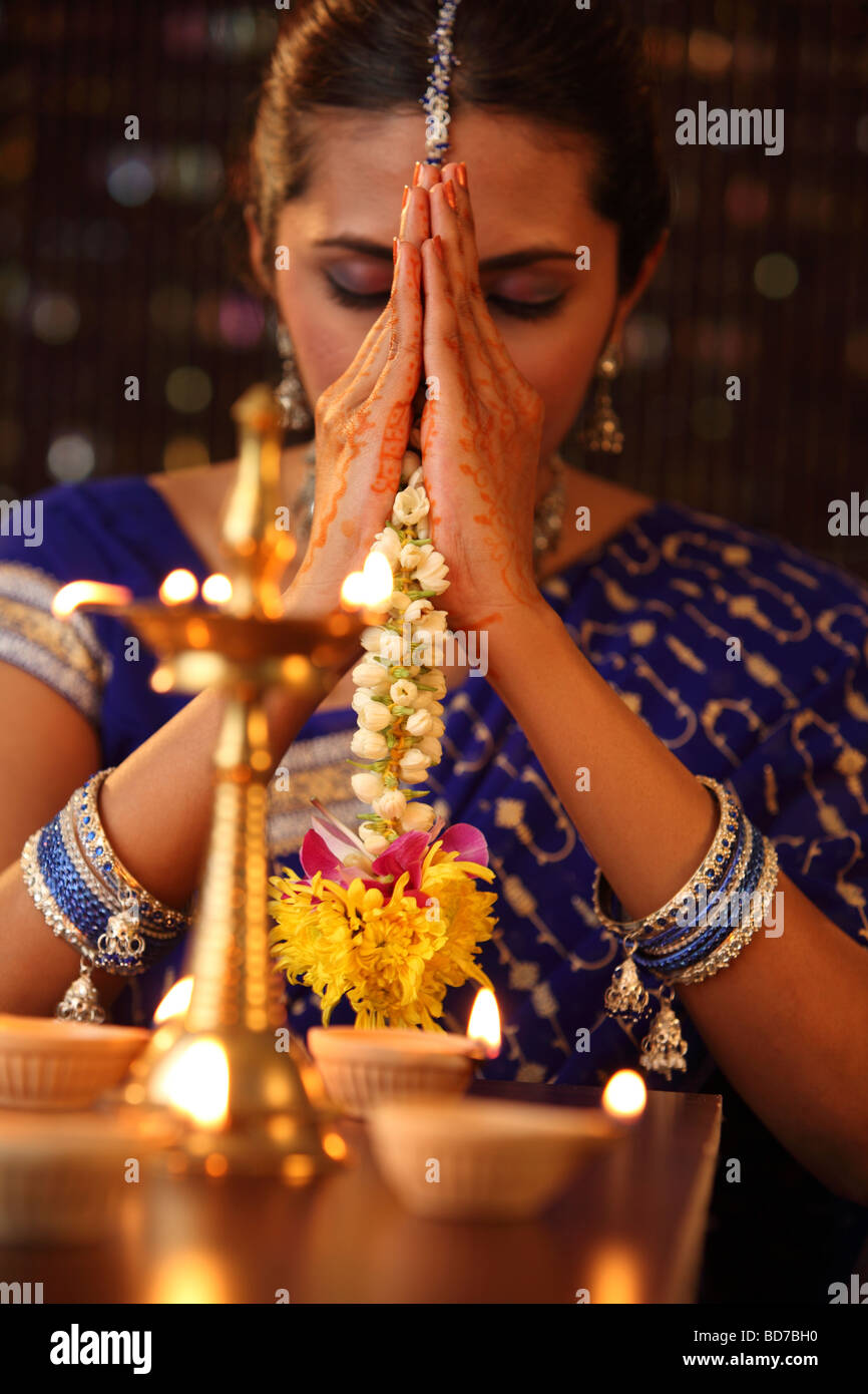 Indian woman praying Stock Photo - Alamy