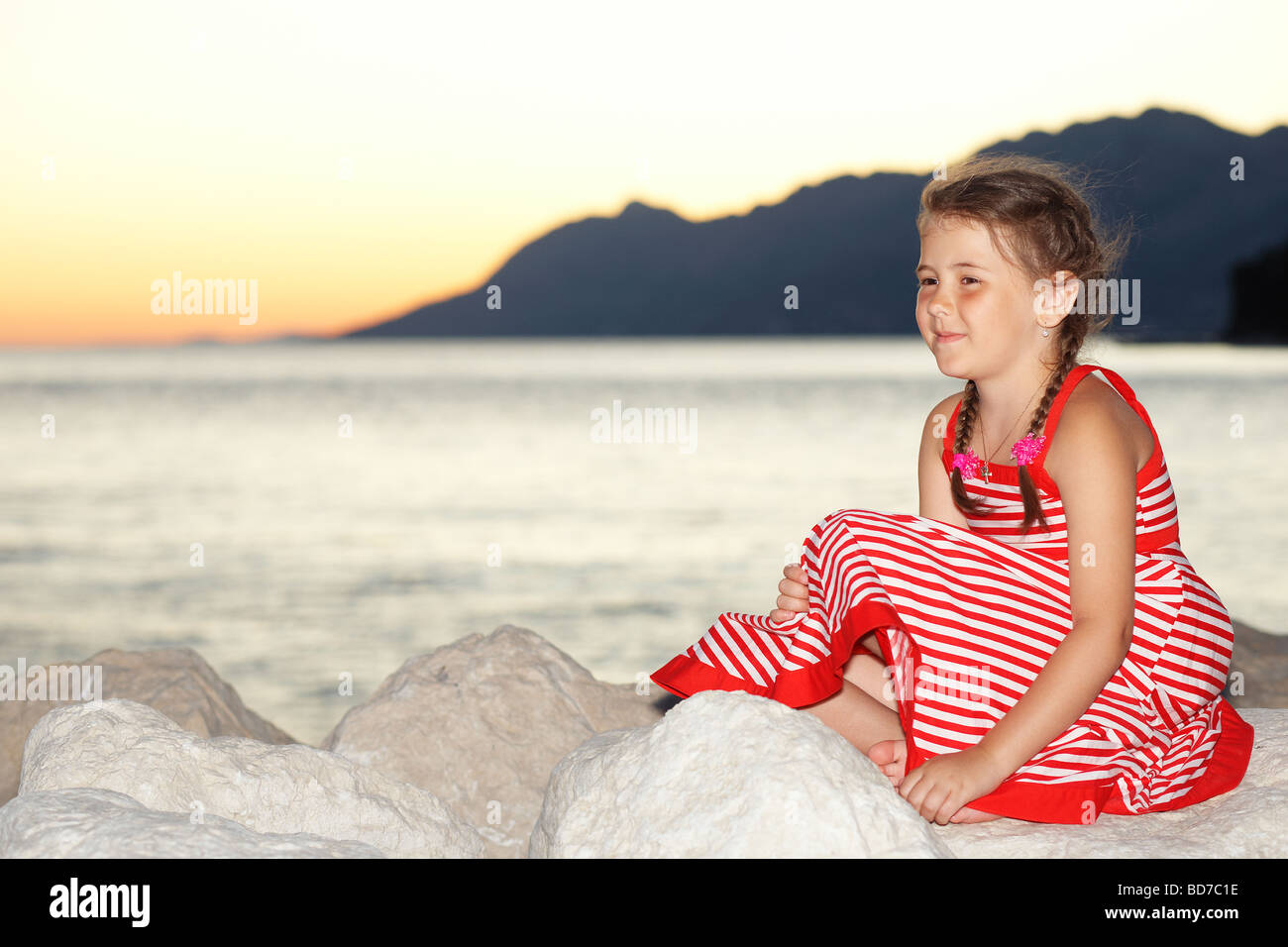Young girl by the sunset Stock Photo - Alamy