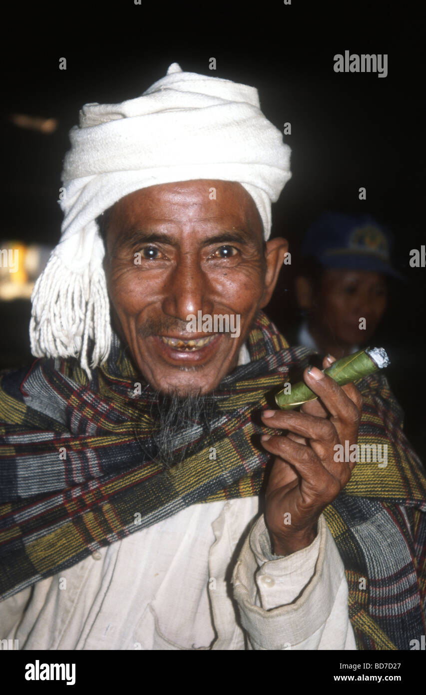Jolly Burmese man in typical clothing and turban,enjoying his ...