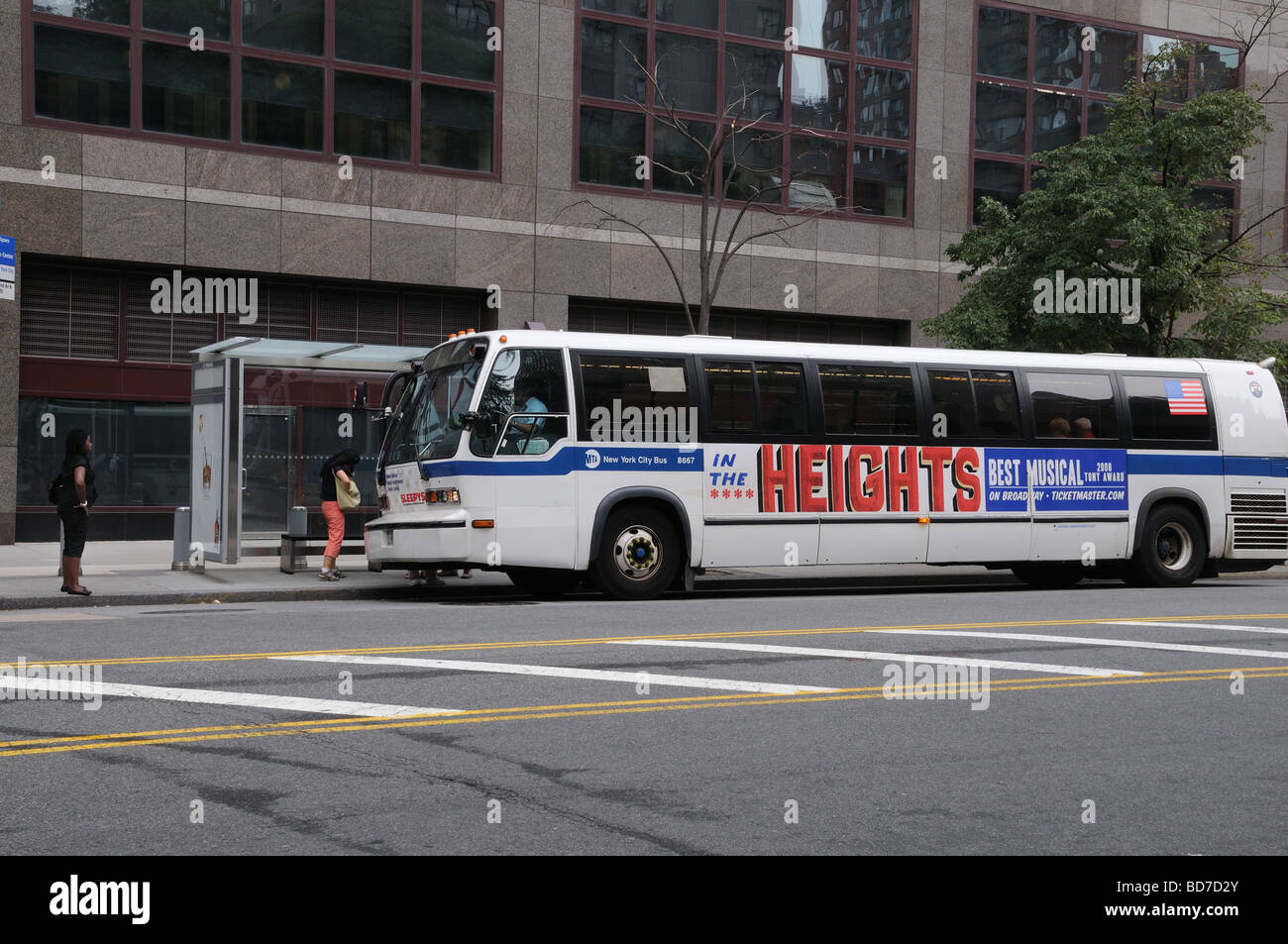 A New York City bus picking up passengers in Battery Park City, a ...