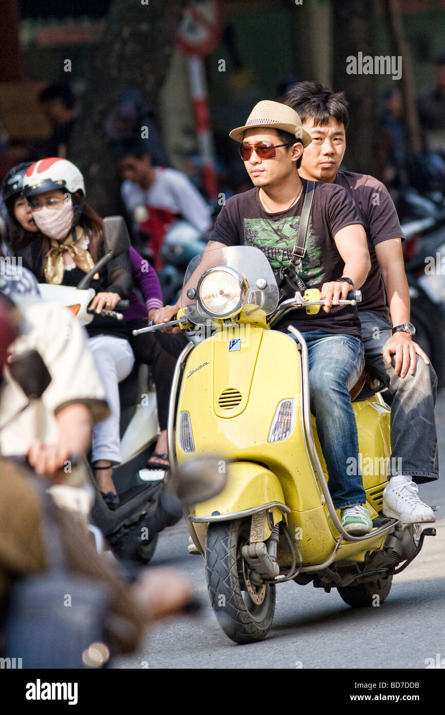 People riding scooters/mopeds in Vietnam in Hanoi Stock Photo - Alamy