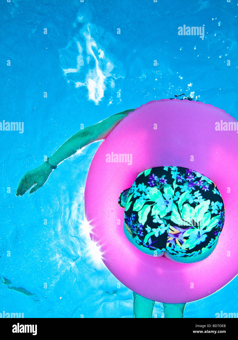 View from below of woman floating in pool Stock Photo - Alamy