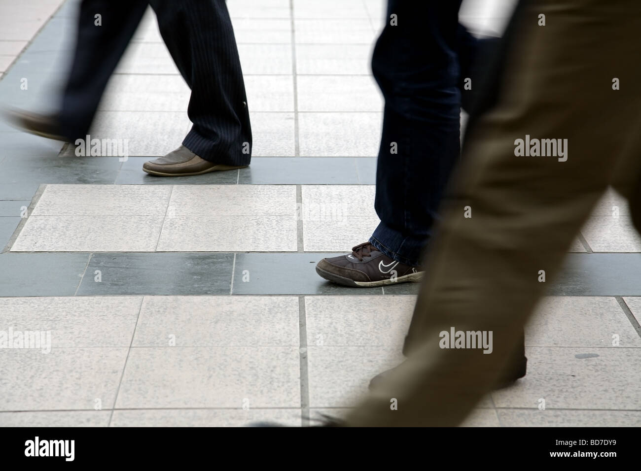 Blurred feet of walking people Stock Photo - Alamy