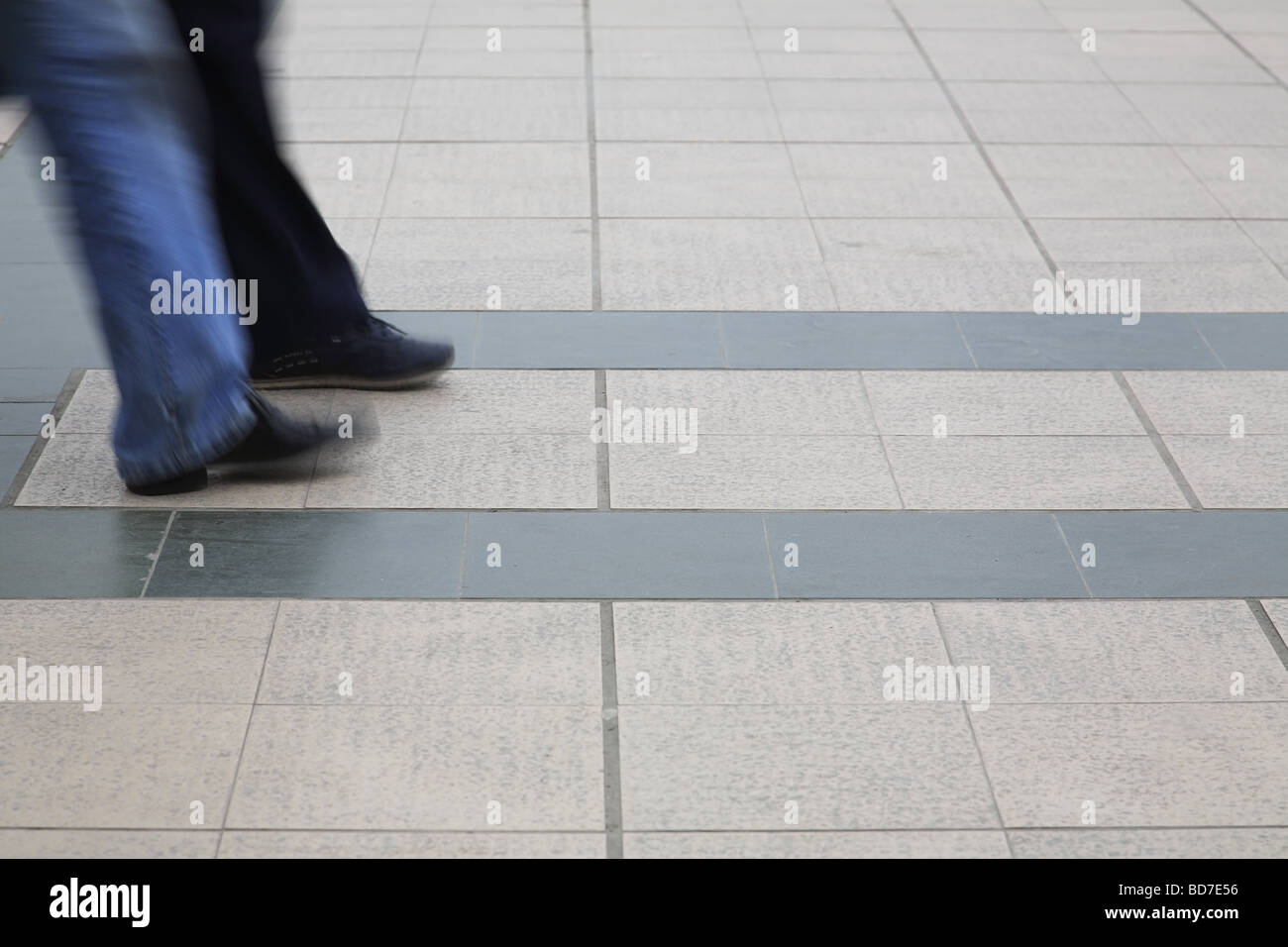 Blurred feet of walking people Stock Photo - Alamy