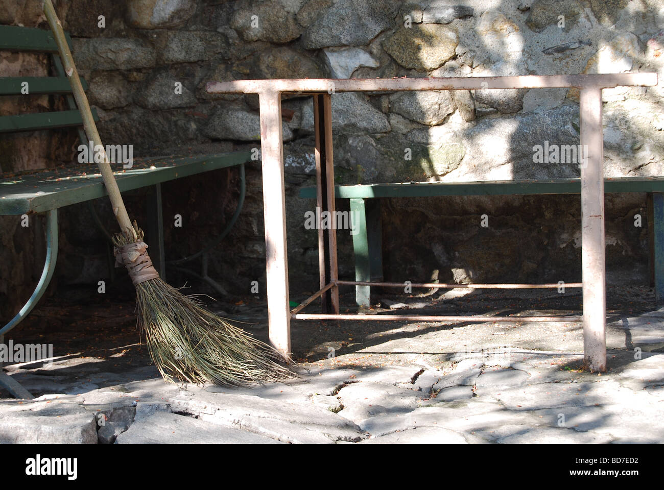 Abandoned broom near a bench and table Stock Photo - Alamy
