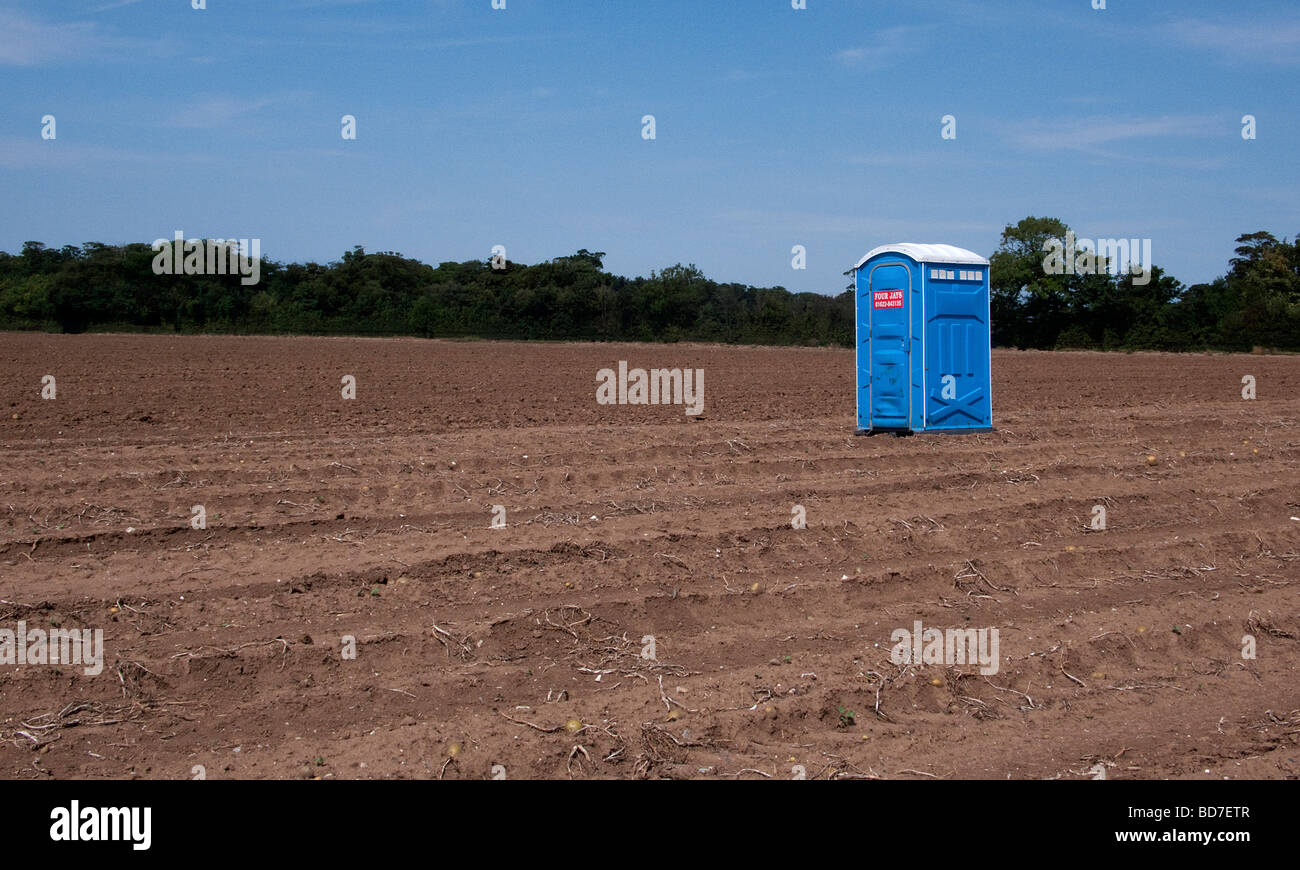 Portable toilet standing in rural field location Stock Photo - Alamy