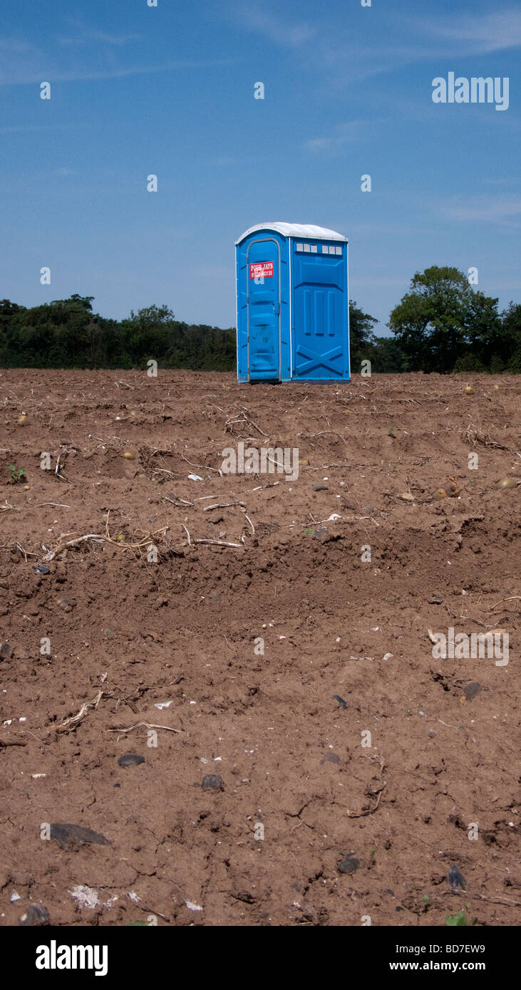 Portable toilet standing in rural field location Stock Photo - Alamy