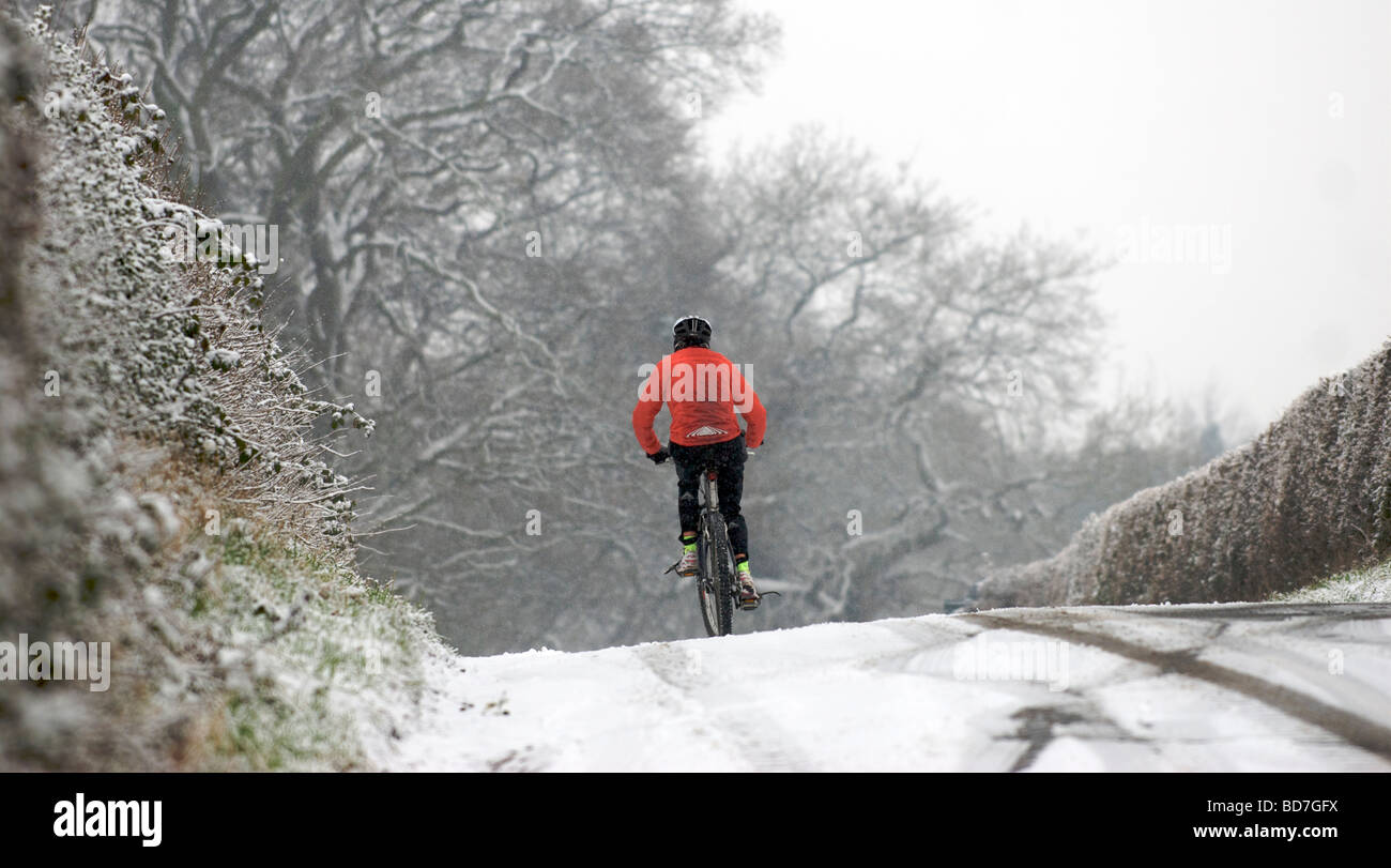 NOT THE WEATHER FOR CYCLING STRUGGLING IN THE SNOW A CYCLIST IN RURAL ...