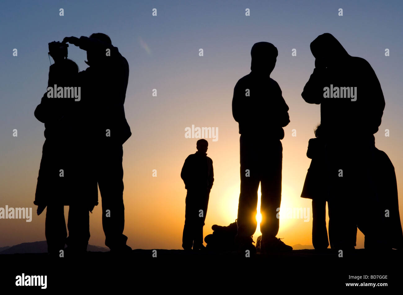People and Sun Lit Sky Stock Photo - Alamy