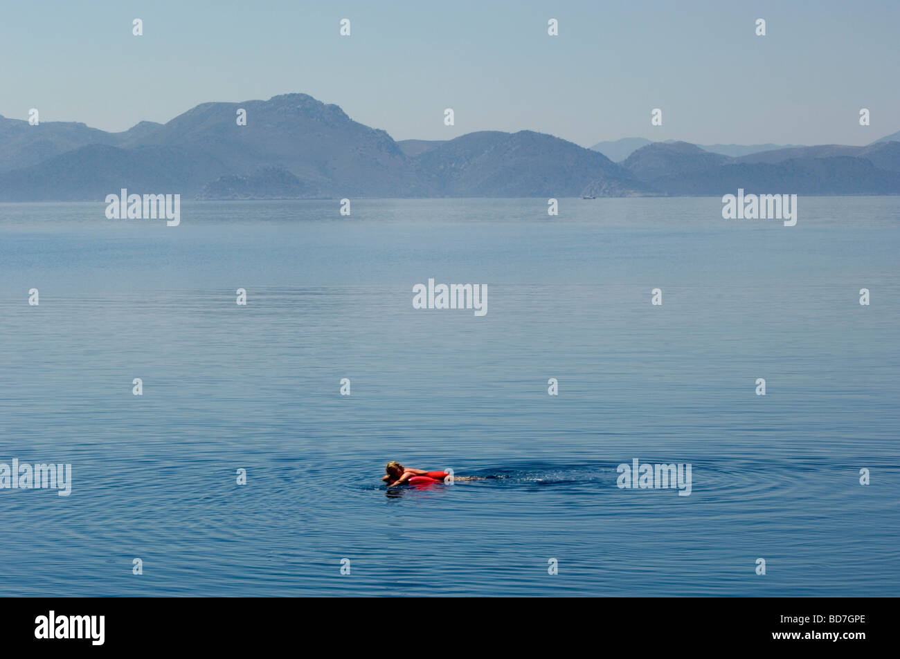 Woman floating in Sea Stock Photo - Alamy