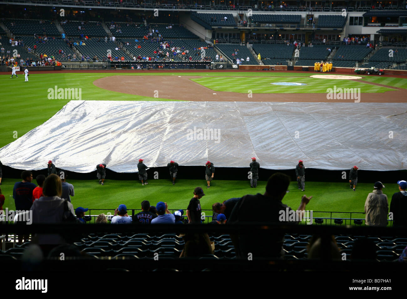 Citi Field grounds crew pulling the tarp off the field after a rain ...