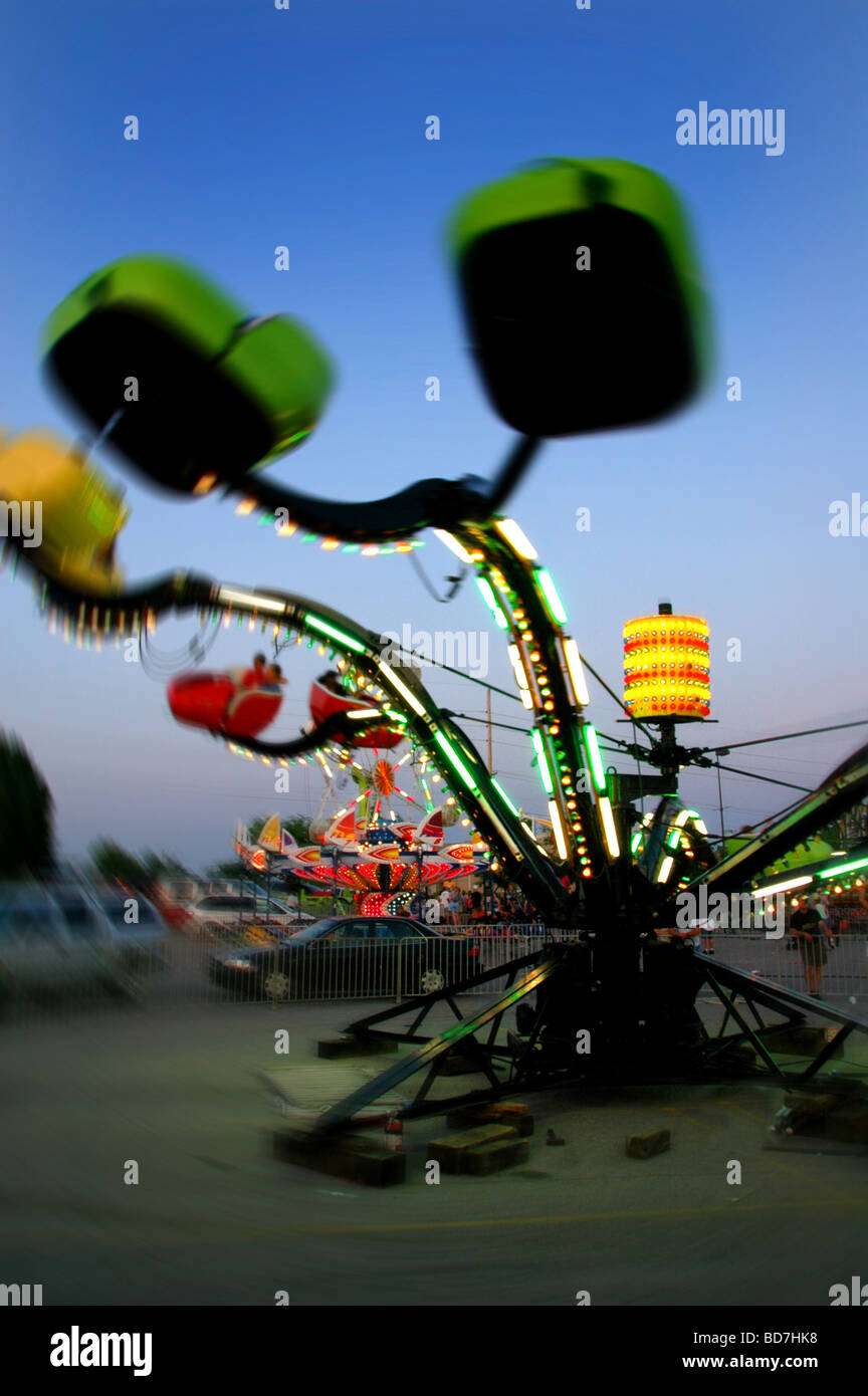 Carnival ride with lights at dusk with motion blur Stock Photo - Alamy