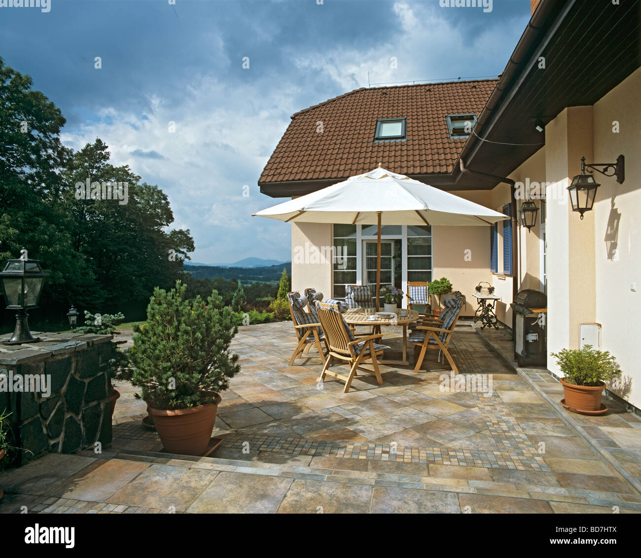 Table with chairs in front of house Stock Photo - Alamy