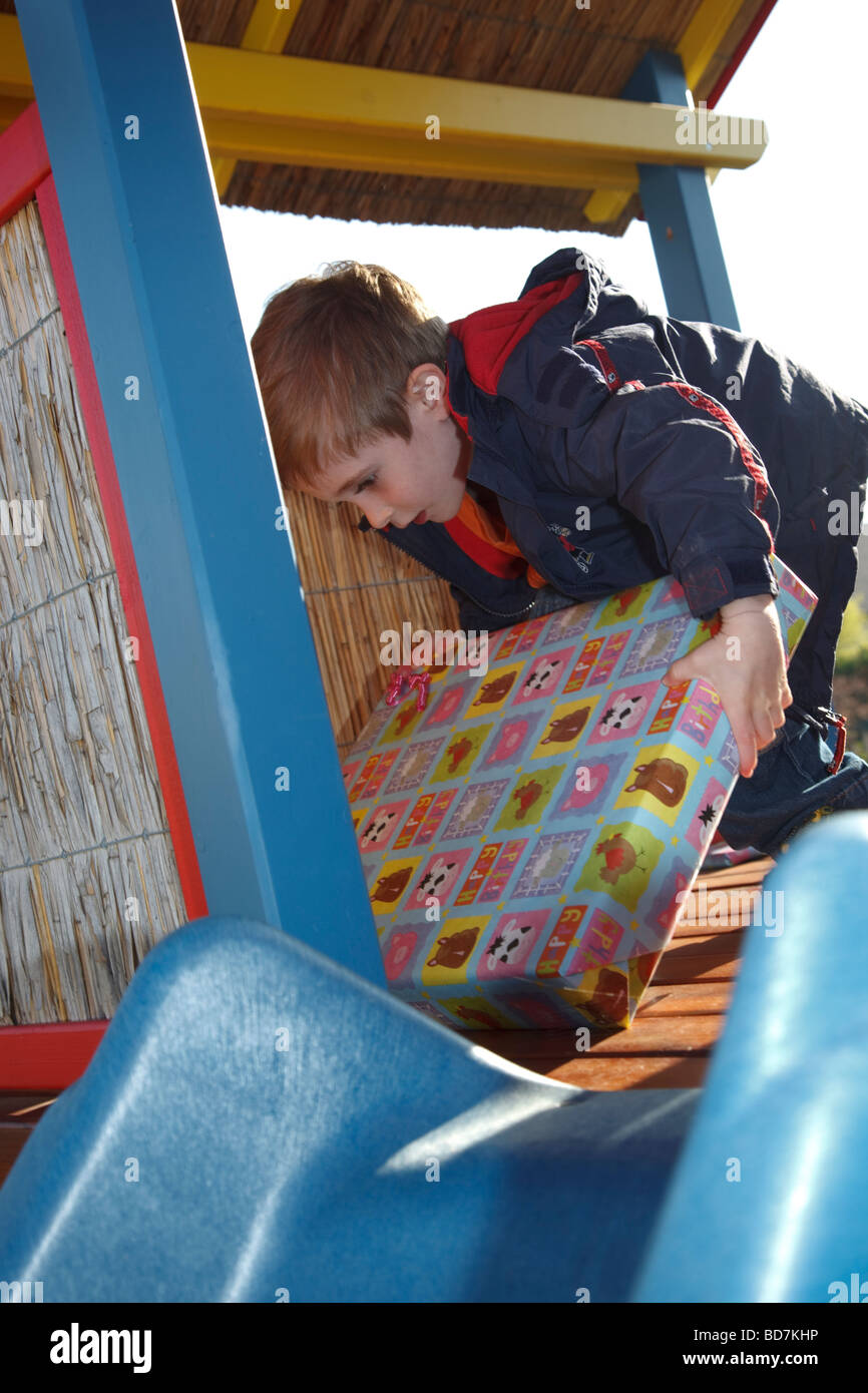 little boy finding present in garden Stock Photo - Alamy