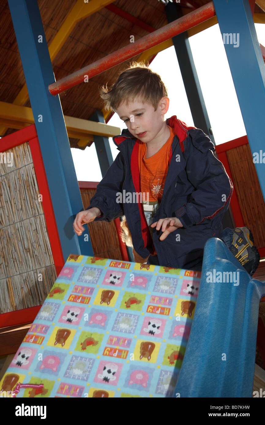 little boy finding present in garden Stock Photo - Alamy