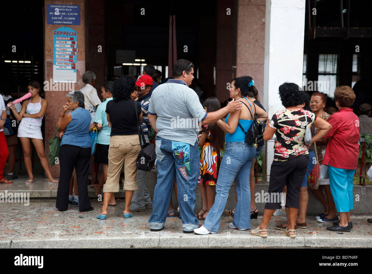 queue of people in front of ice cream shop Stock Photo - Alamy