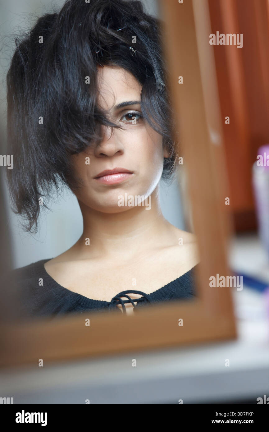 young woman seeing herself in the mirror Stock Photo - Alamy