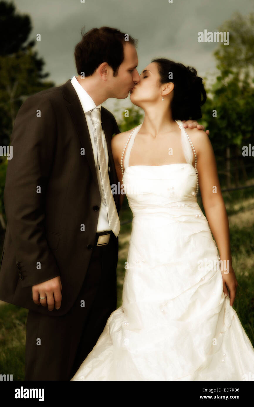 bride and bride gromm kissing each other Stock Photo - Alamy