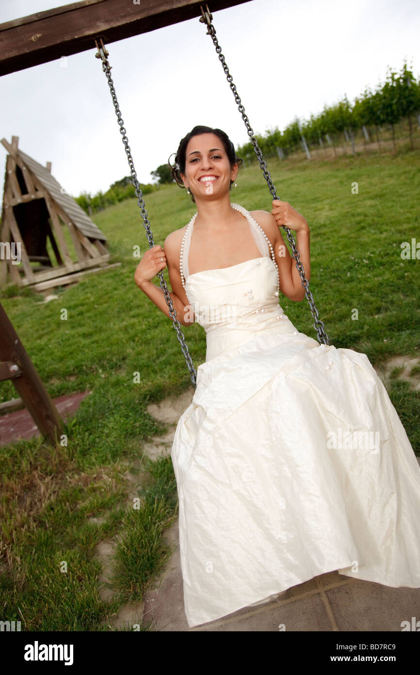 bride sitting on swing Stock Photo - Alamy