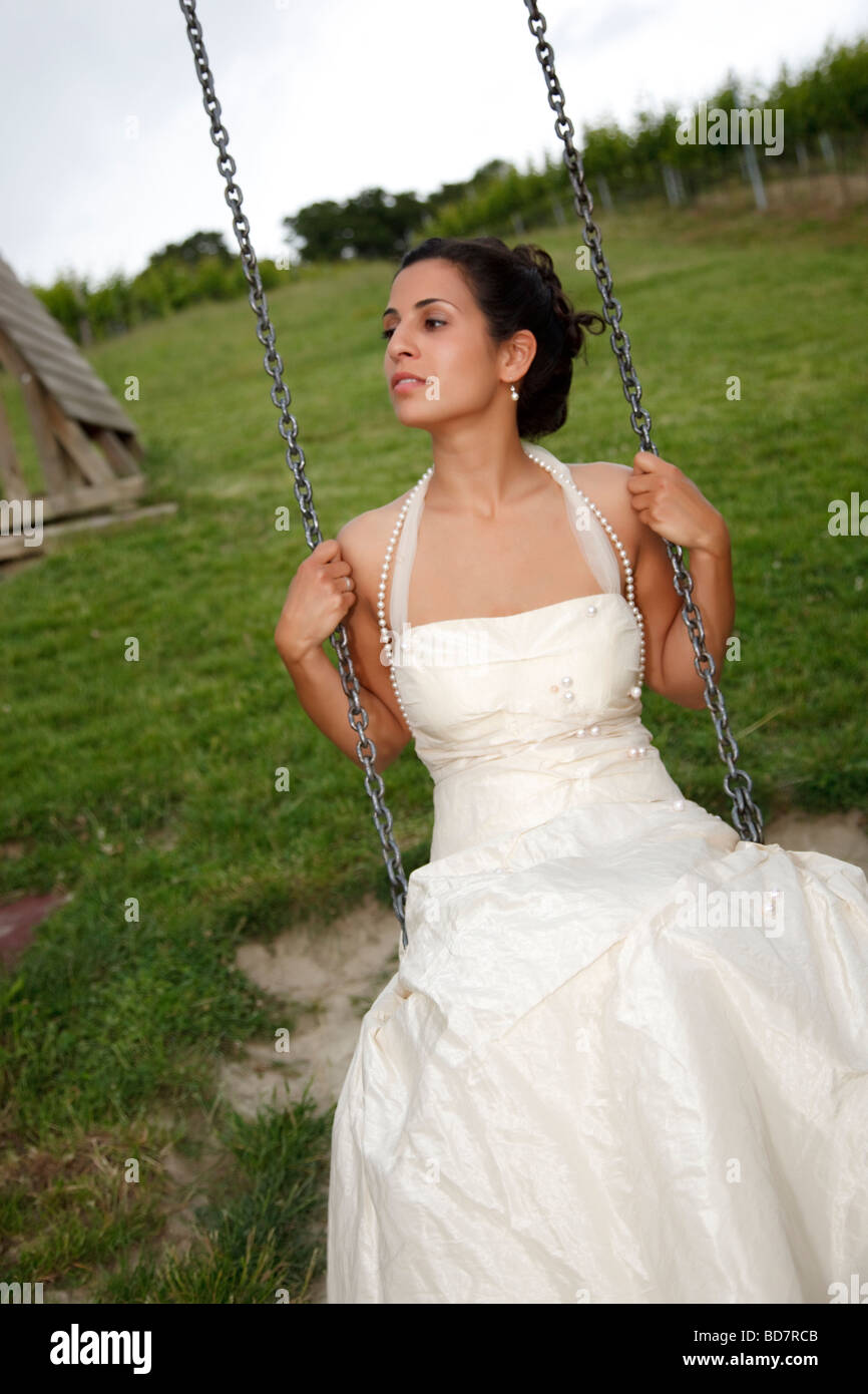 bride sitting on swing Stock Photo - Alamy