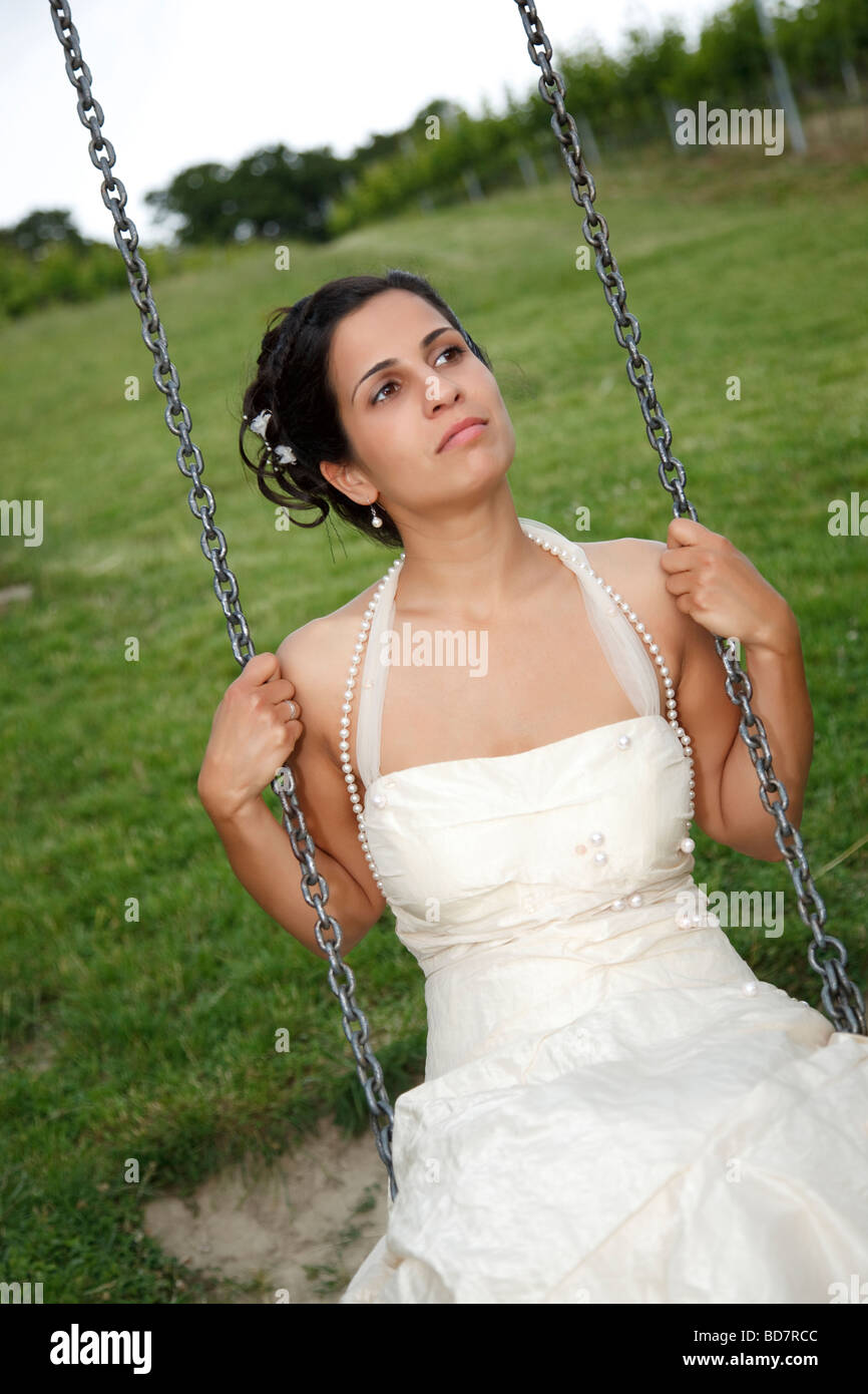 bride sitting on swing Stock Photo - Alamy