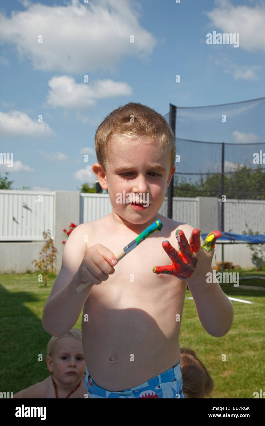 boy painting with color Stock Photo - Alamy