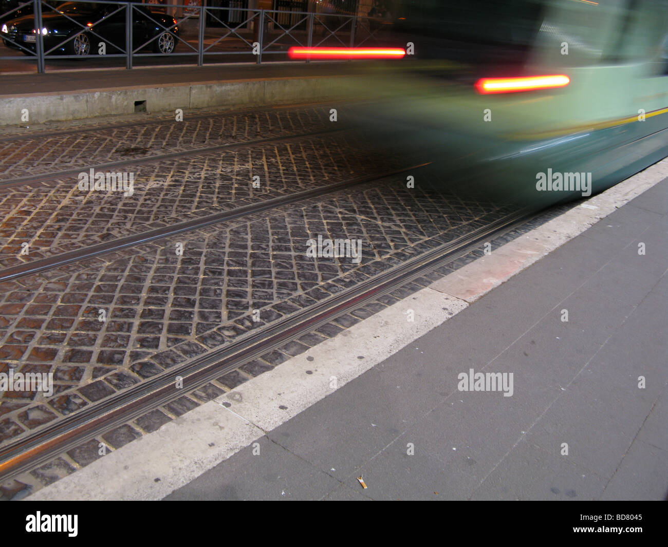 fast metro tram carriage on tracks in city at night Stock Photo - Alamy