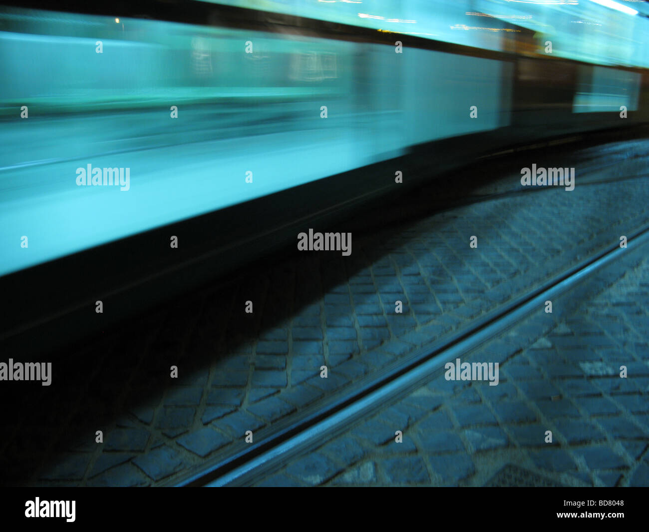 fast metro tram carriage on tracks in city at night Stock Photo - Alamy