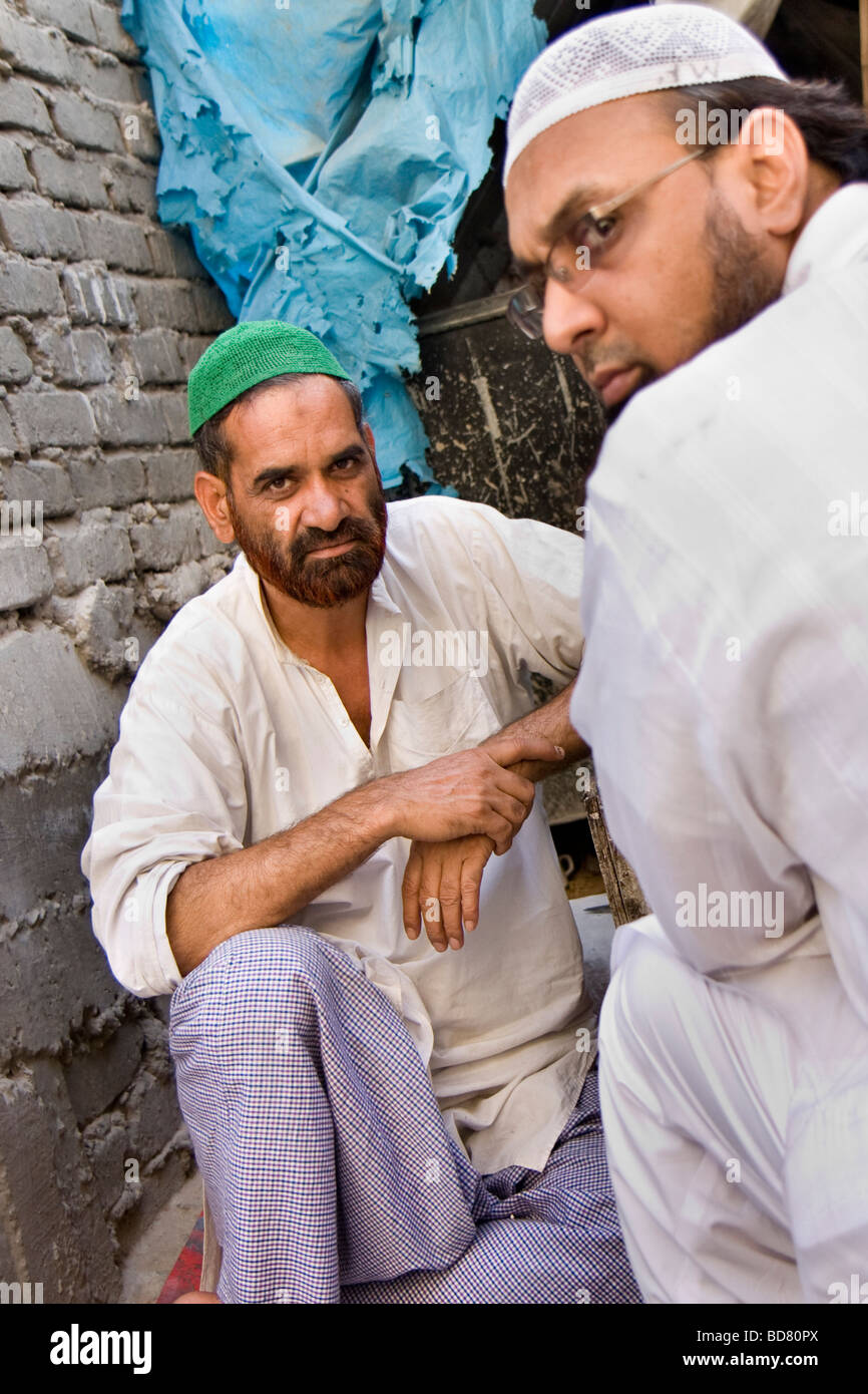 Two Indian men sitting down Stock Photo - Alamy