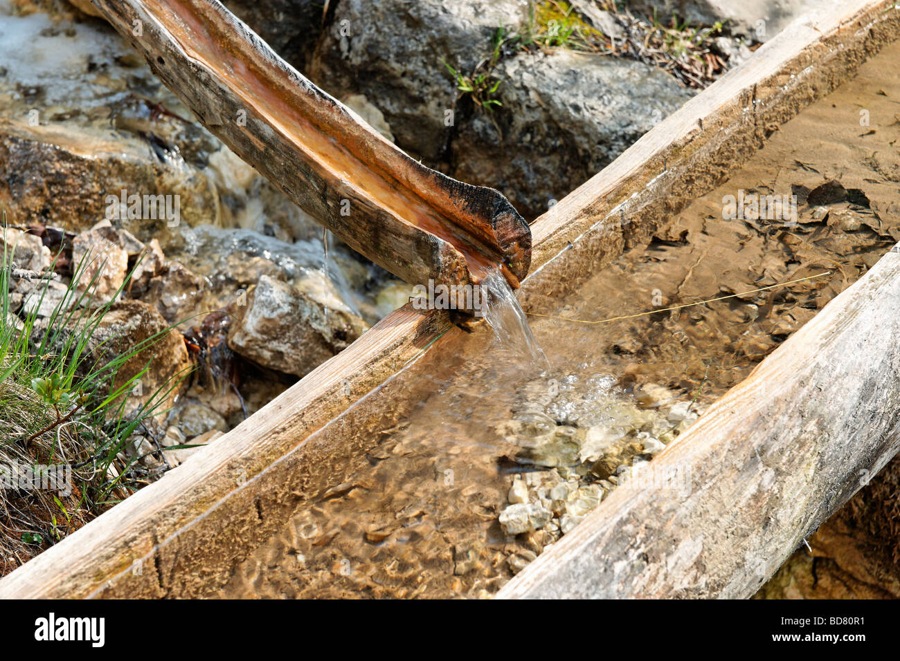 Wooden water trough fed by a stream Slovenia Stock Photo - Alamy