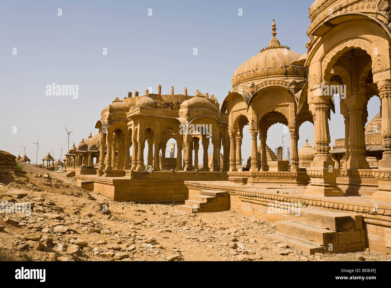A wind turbine farm contrasts with the ancient carved memorials at Bada ...