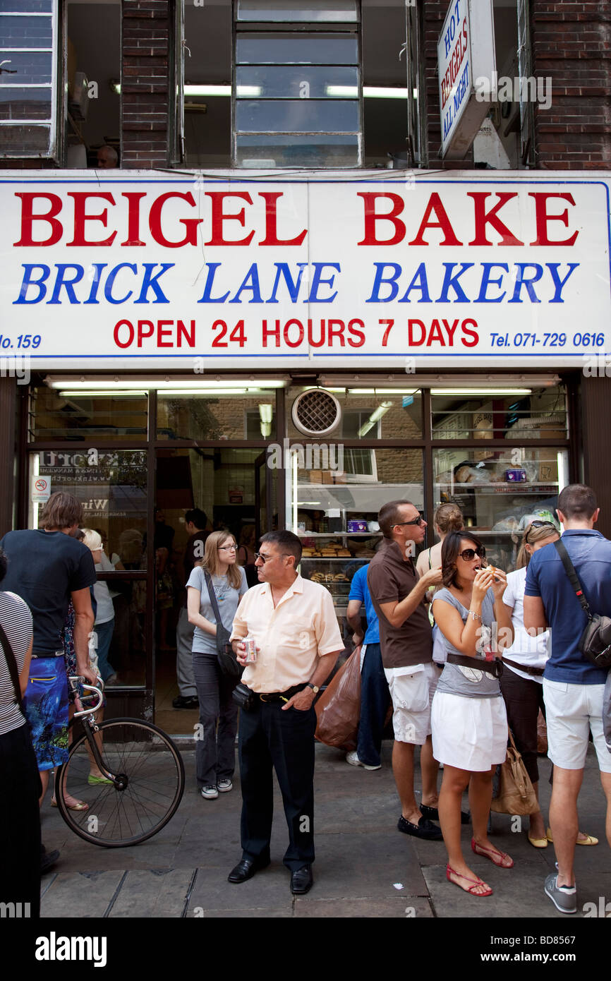 People eating outside famous Bagel Bake bakery on Brick lane on Sunday ...