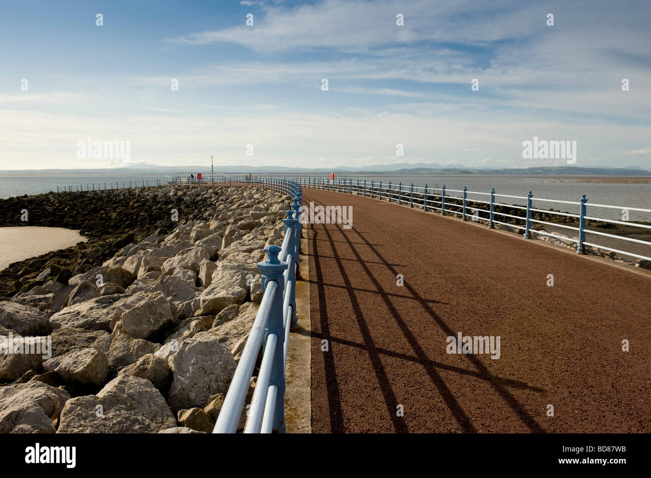 Stone Jetty looking towards the sea with unidentifiable figures in the ...