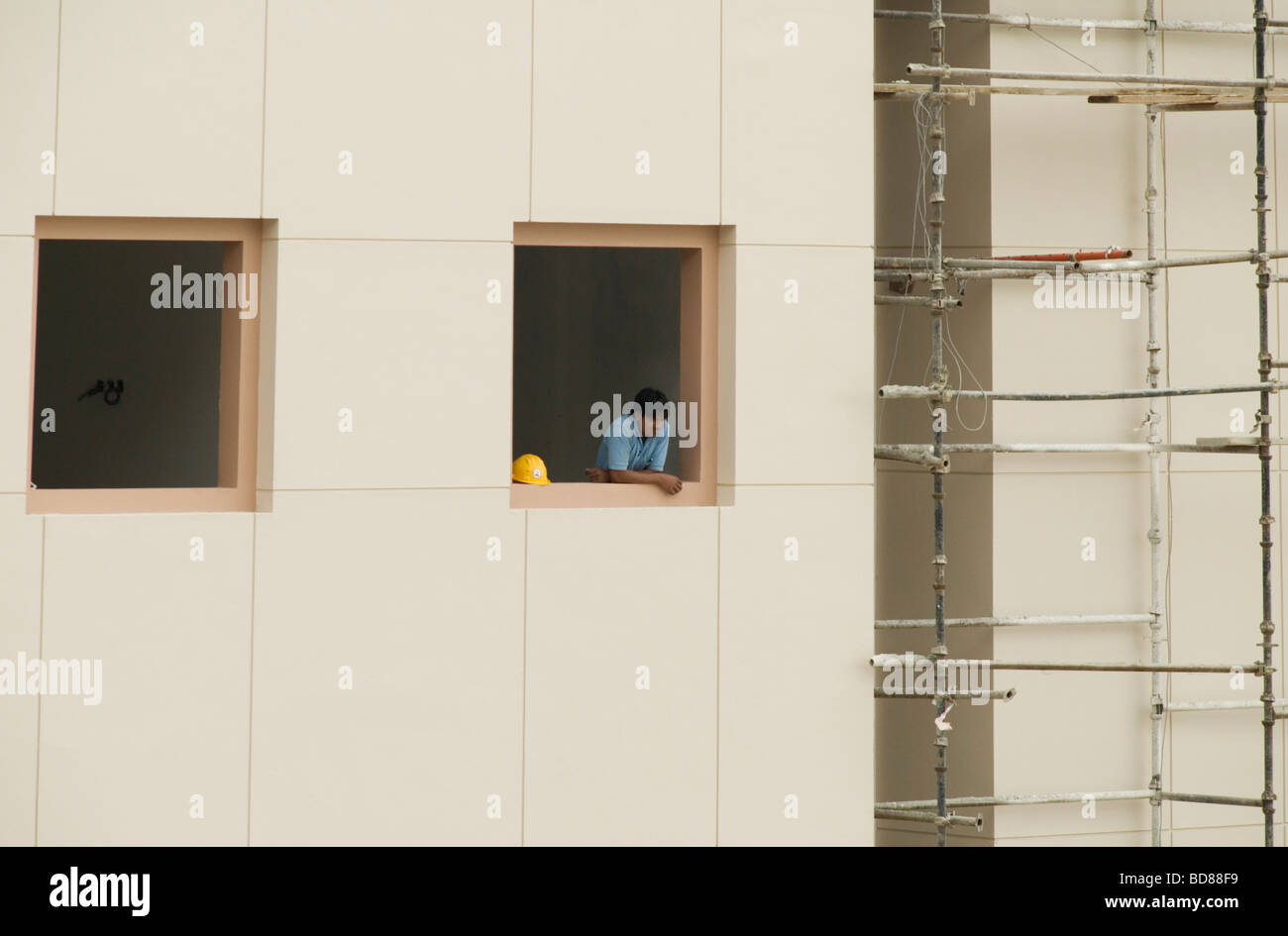 Construction worker taking a break looking out a window Stock Photo - Alamy