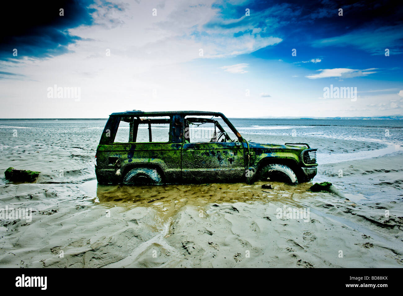 Abandoned car partially buried in sand Morecambe Bay Stock Photo - Alamy