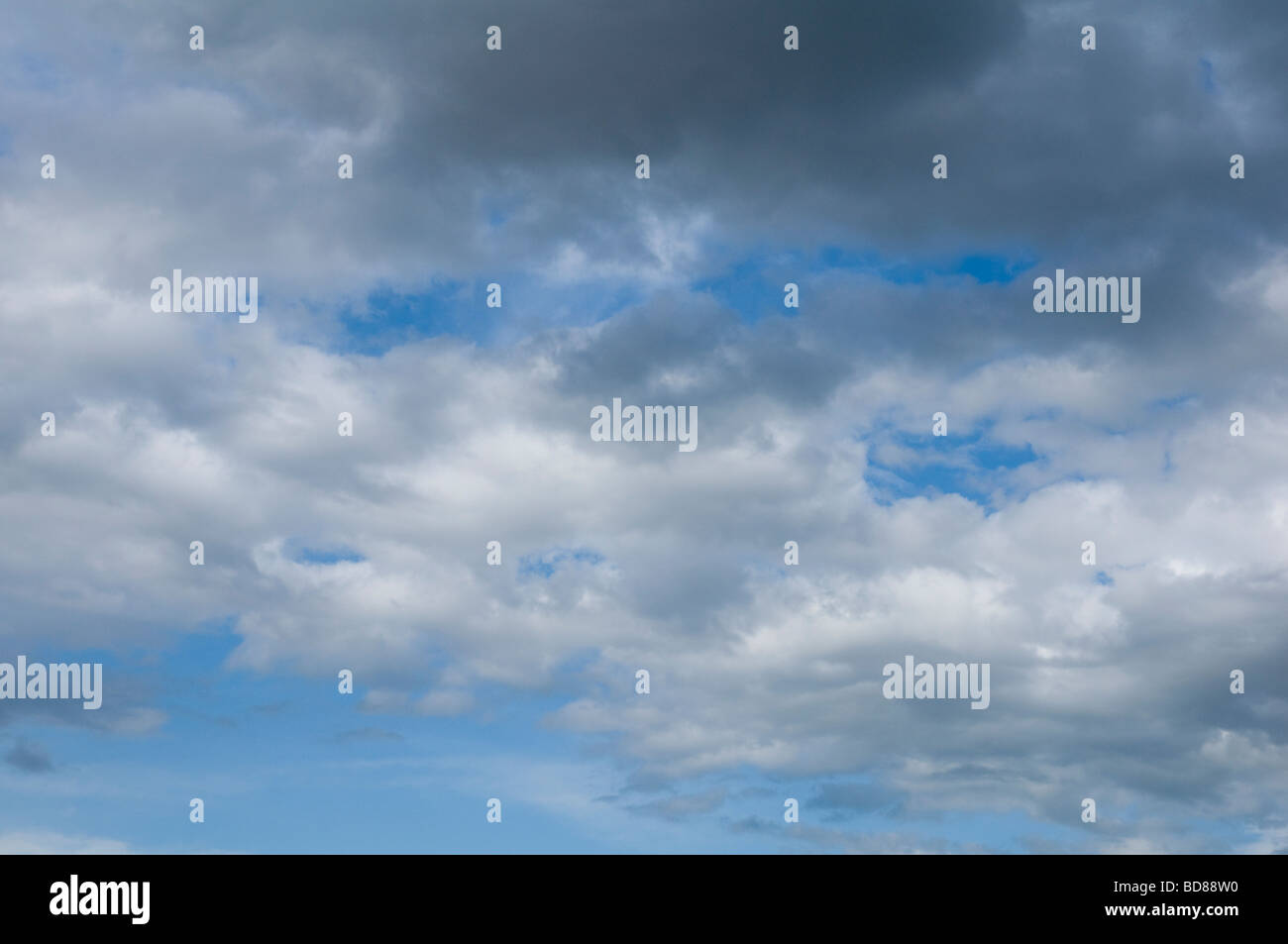 Blue sky with foreboding grey and dark rain clouds forming Stock Photo ...