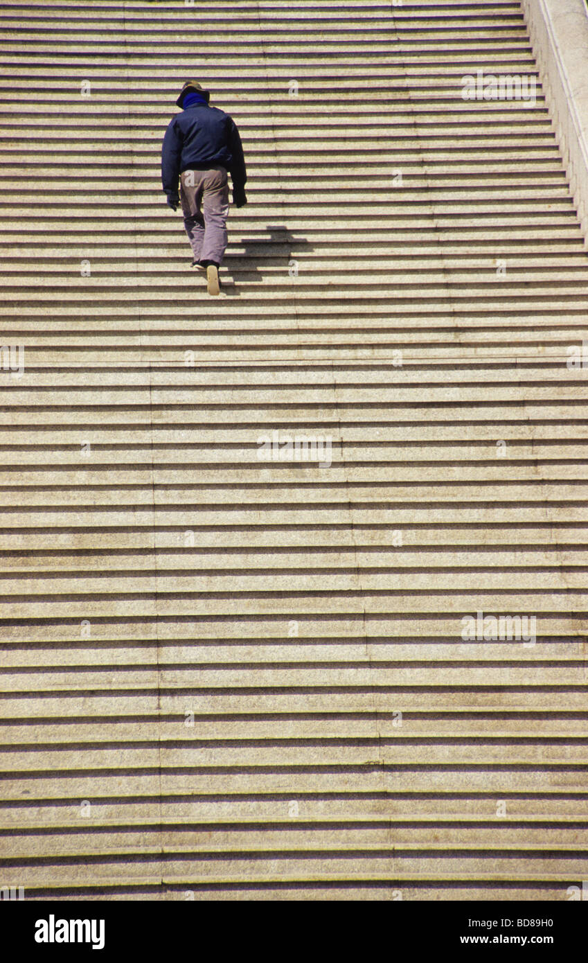 Man climbing a wide staircase Stock Photo - Alamy